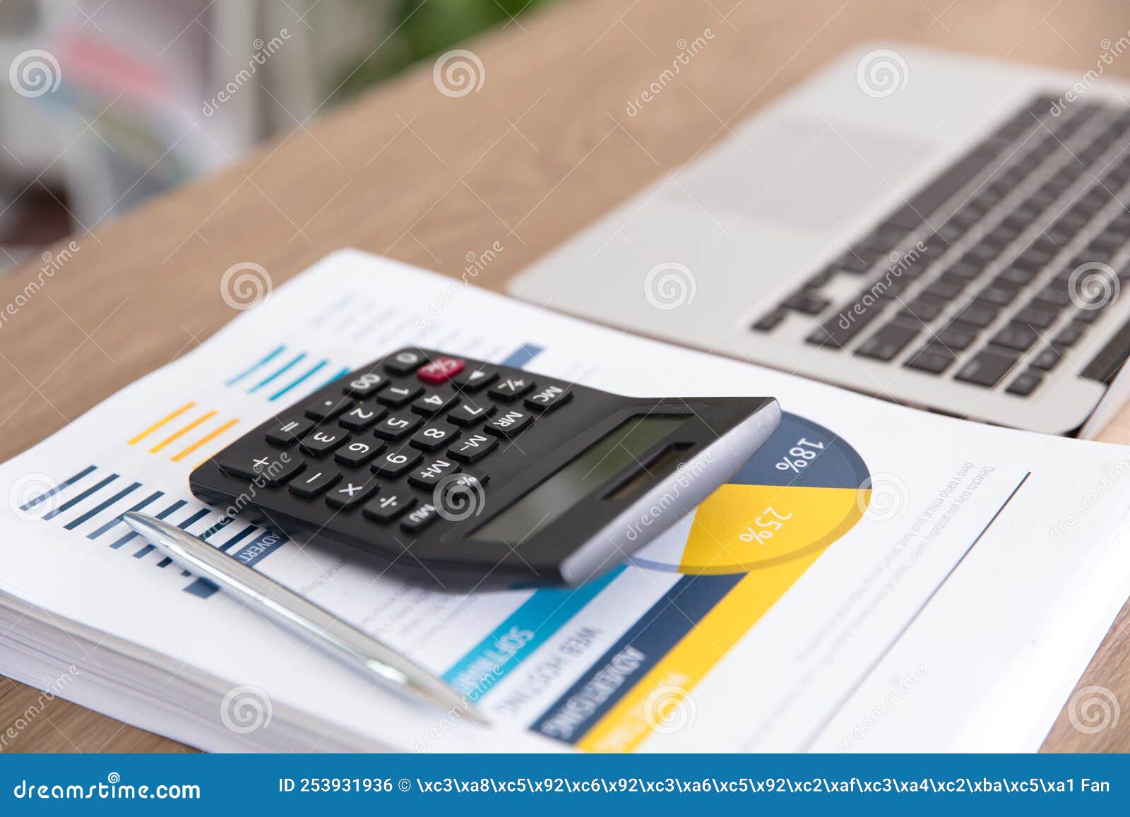 Calculator on a Stack of Data and Computer Next To it Stock Photo ...