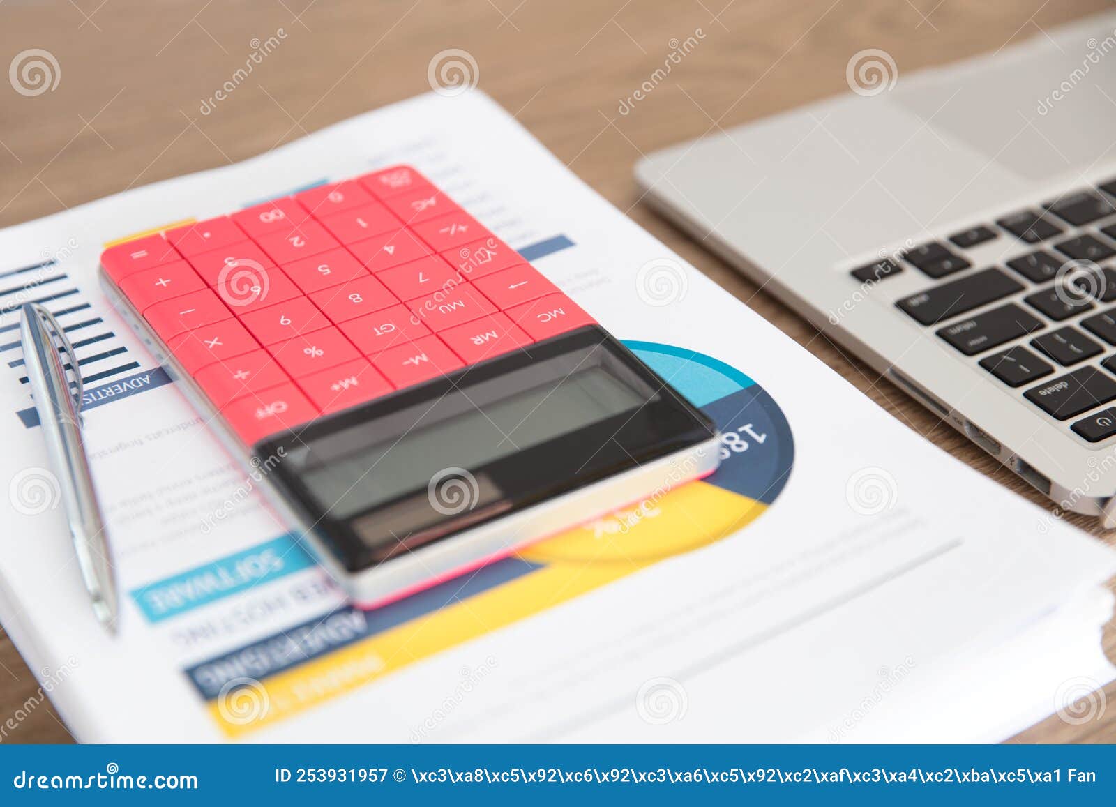 A Calculator on a Stack of Documents and a Computer Next To it Stock ...