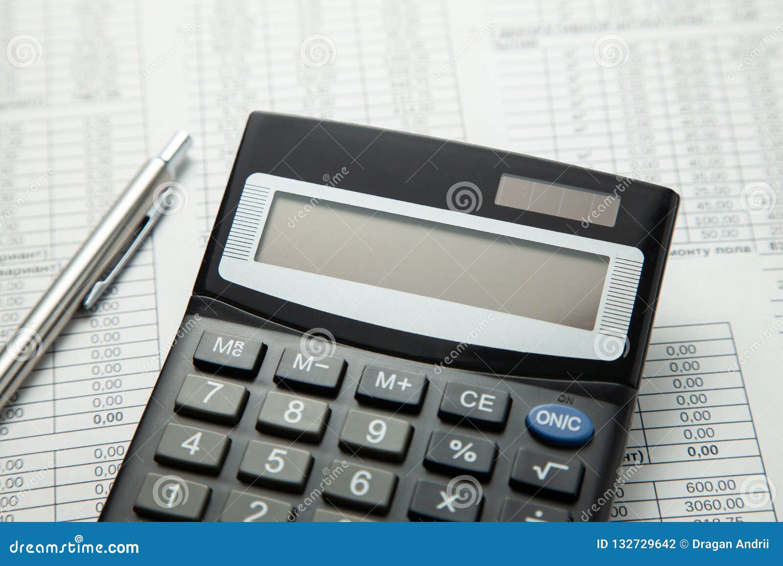 Calculator on the Table with Paper Tables and Pen Stock Photo - Image ...