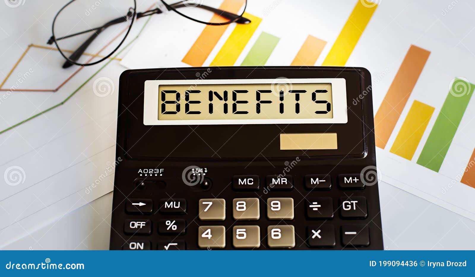 Calculator with the Word BENEFITS on the Display with Chart and Glasses ...