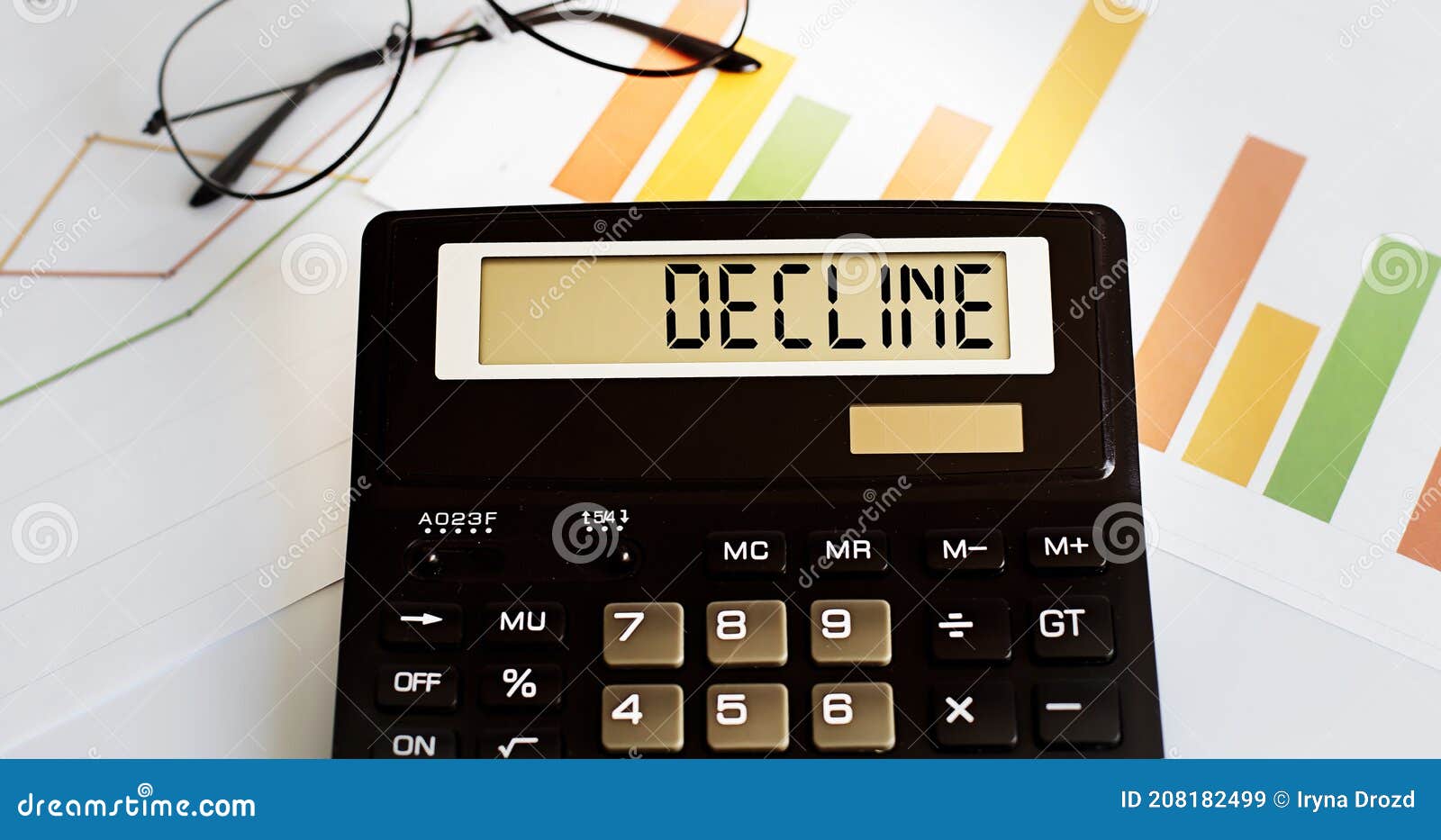Calculator with the Word DECLINE on the Display with Chart and Glasses ...