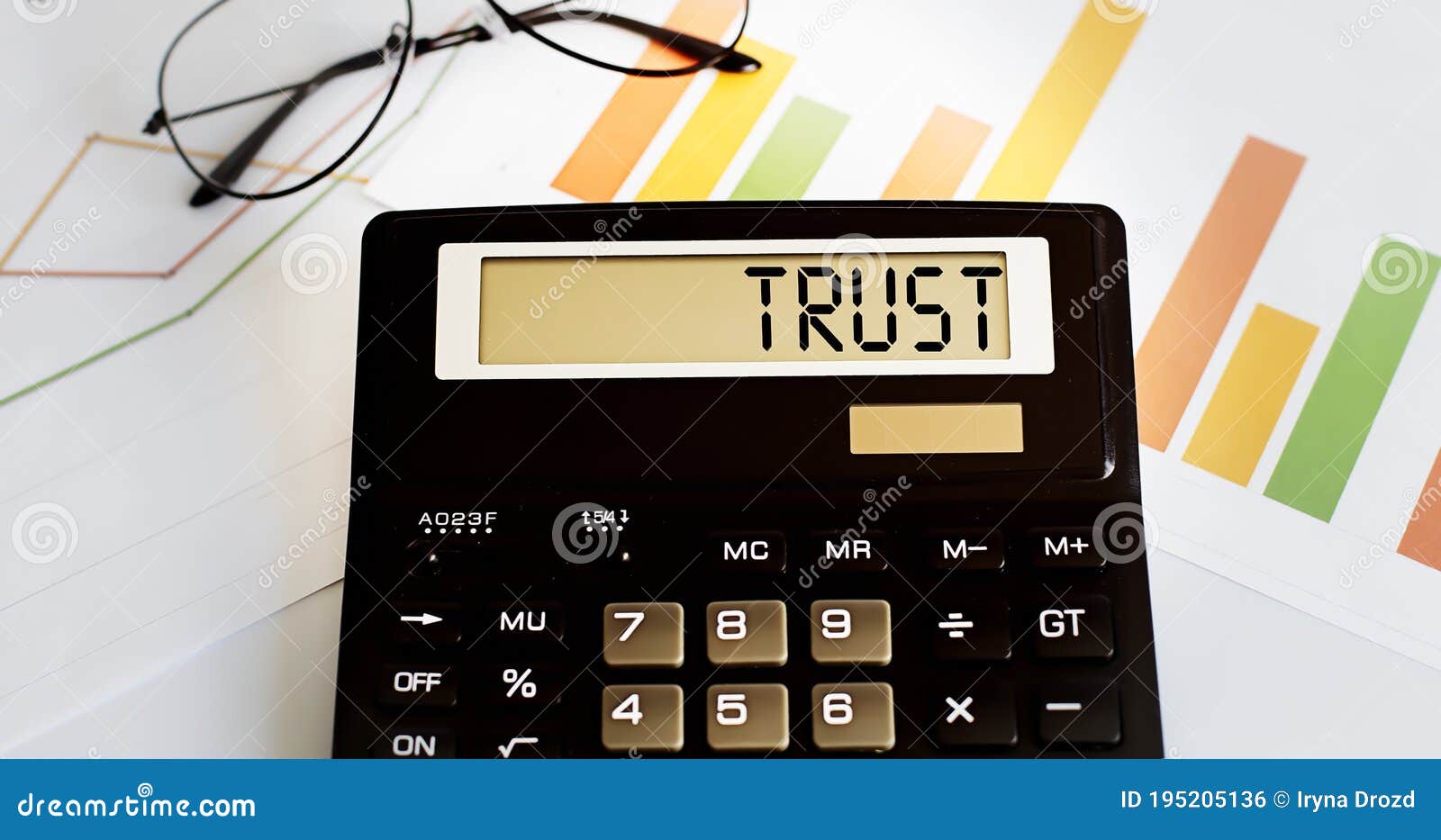 Calculator with the Word TRUST on the Display with Chart and Glasses ...