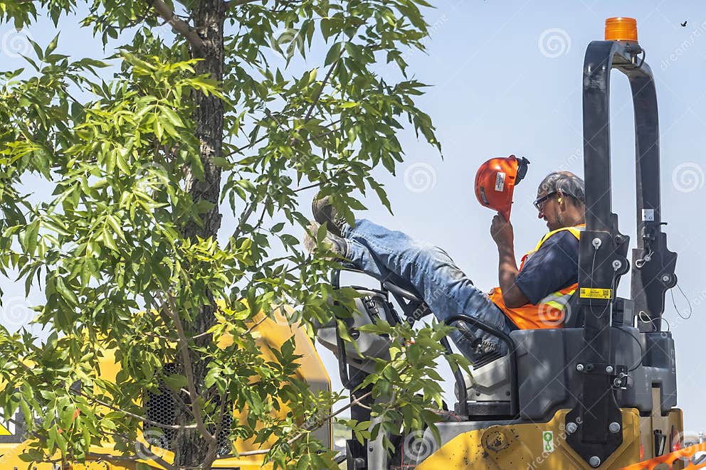 A Construction Worker Resting during a Break in a Hot Summer Day ...