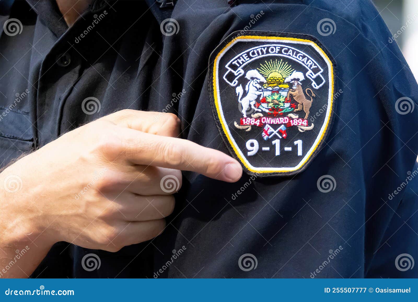 A Close Up To a Paramedic Staff Pointing To a Uniform 911 Batch ...