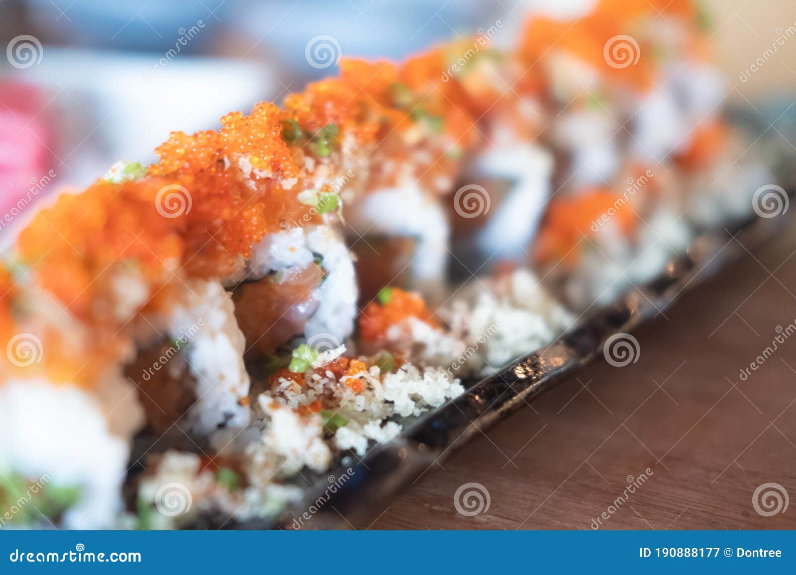 California Roll Topped with Fresh Salmon and Salmon Roe Served on ...