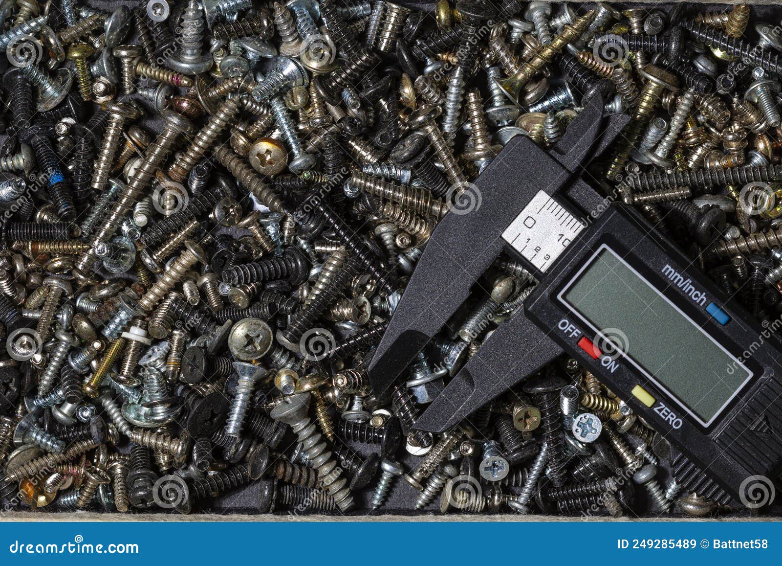 Caliper and Various Types of Fasteners on a Wooden Brown Background ...