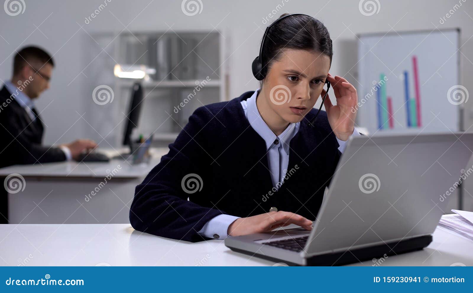 Call Center Manager in Headset Checking Data on Laptop, Customer ...