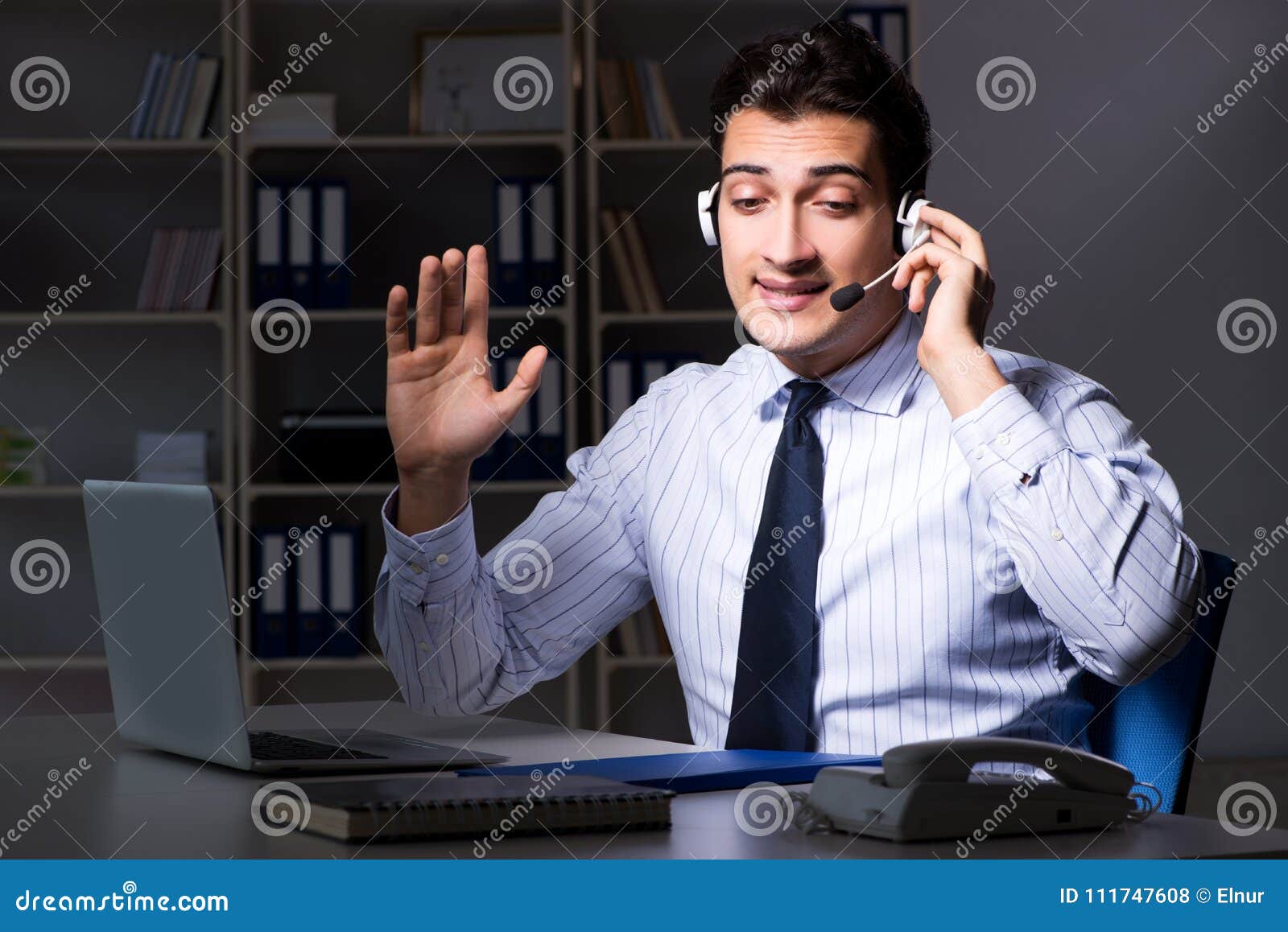 The Call Center Operator Talking To Customer during Night Shift Stock ...