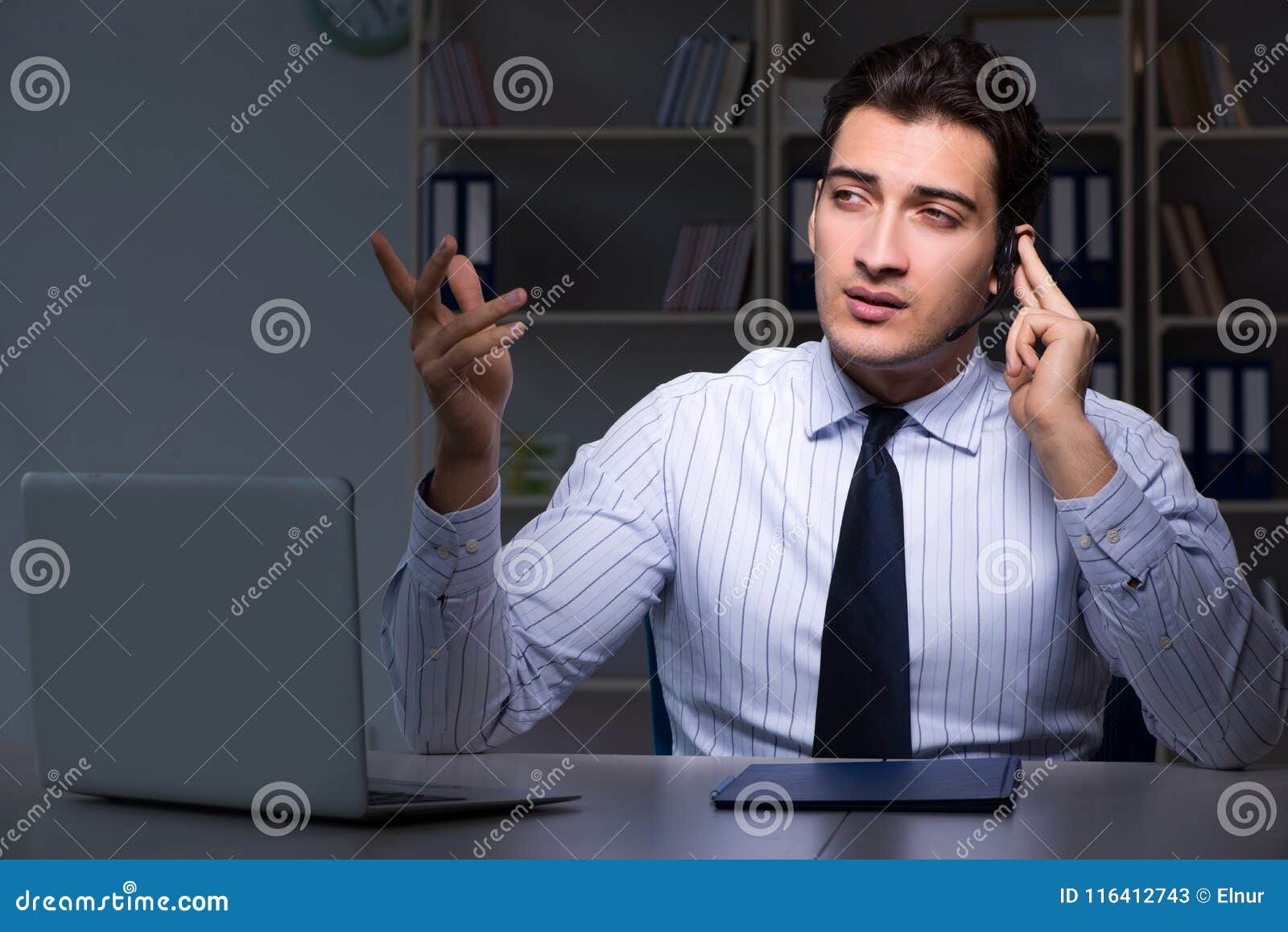 The Call Center Operator Talking To Customer during Night Shift Stock ...