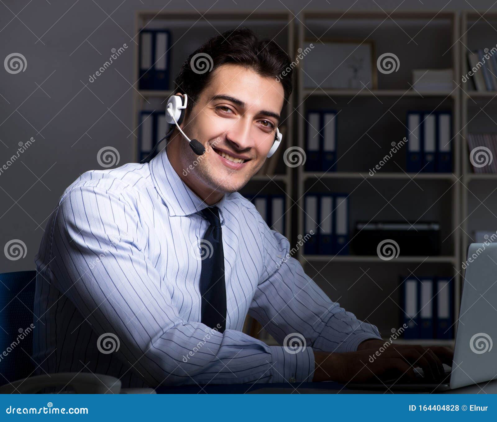 Call Center Operator Talking To Customer during Night Shift Stock Photo ...