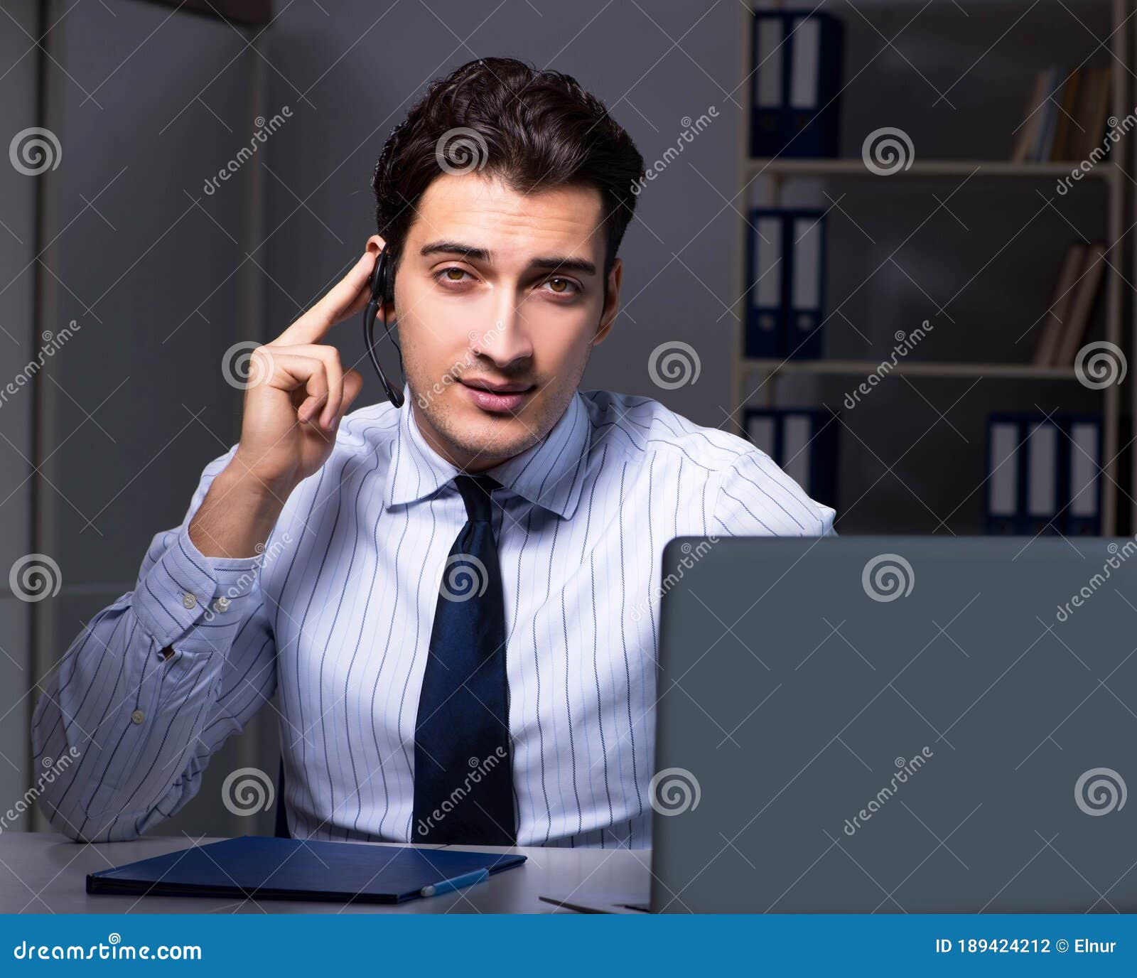 Call Center Operator Talking To Customer during Night Shift Stock Photo ...