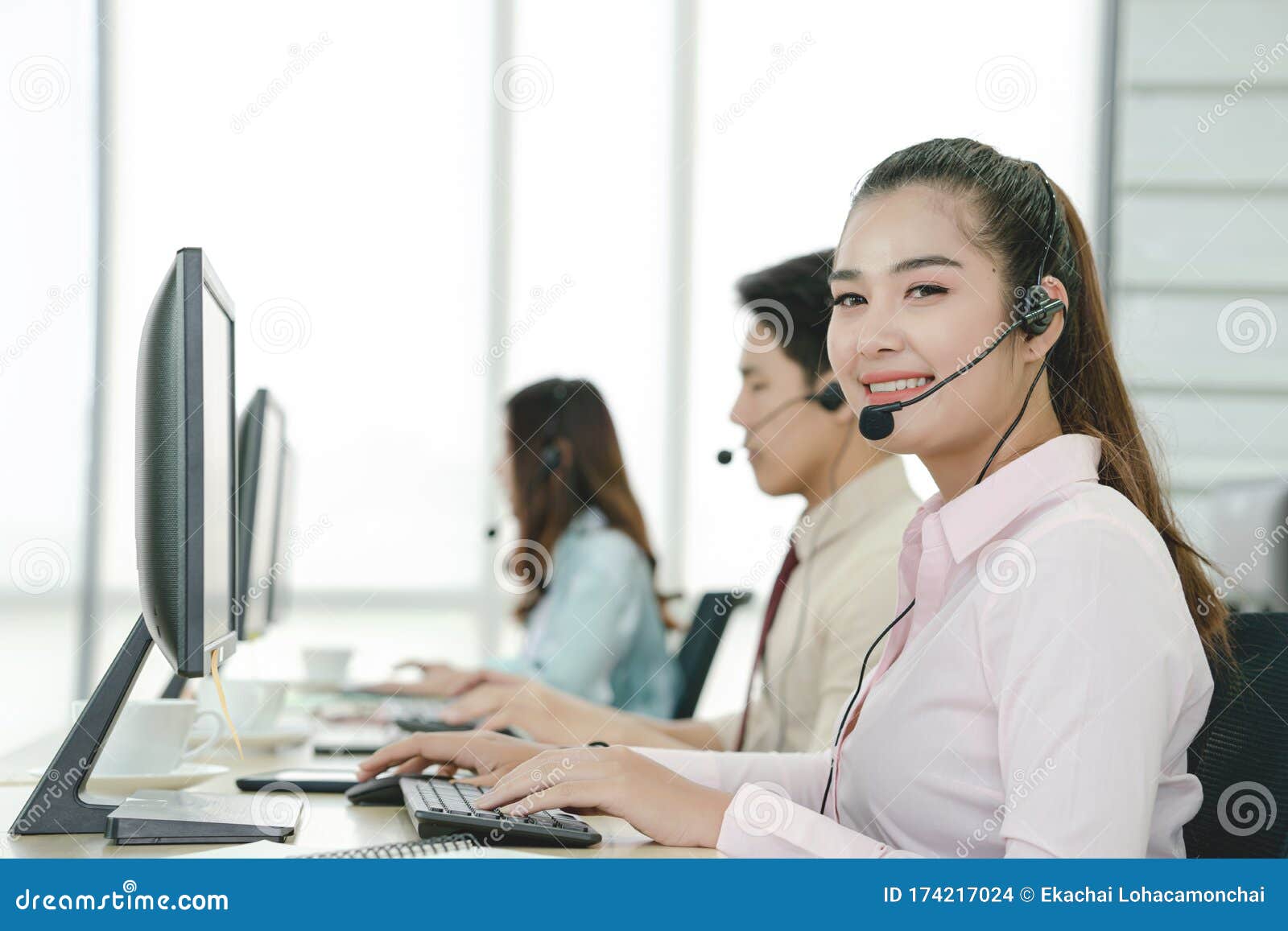 Call Center Worker Accompanied by Her Team Stock Photo - Image of ...