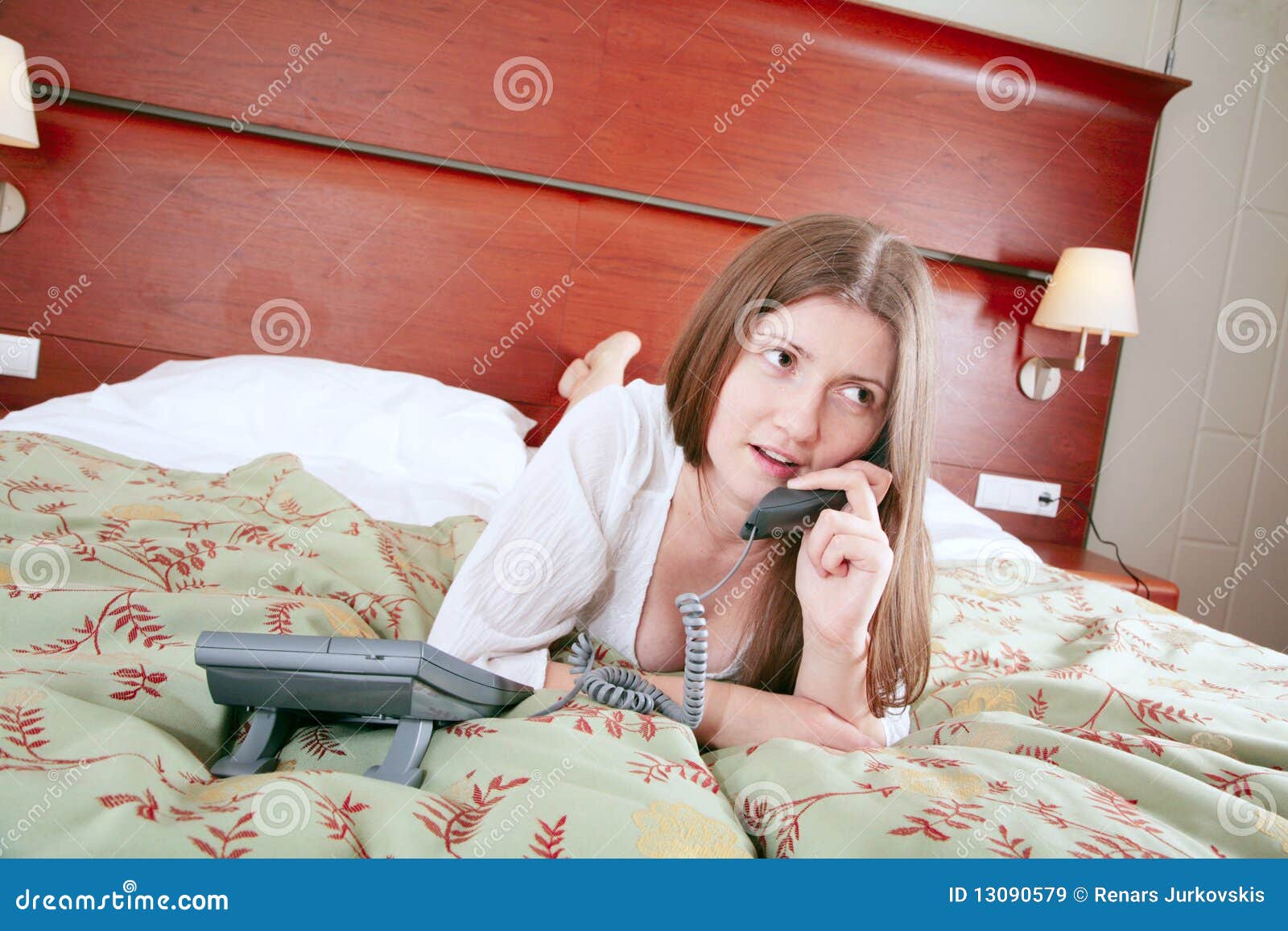 Calling for room service stock image. Image of cute, brunette - 13090579