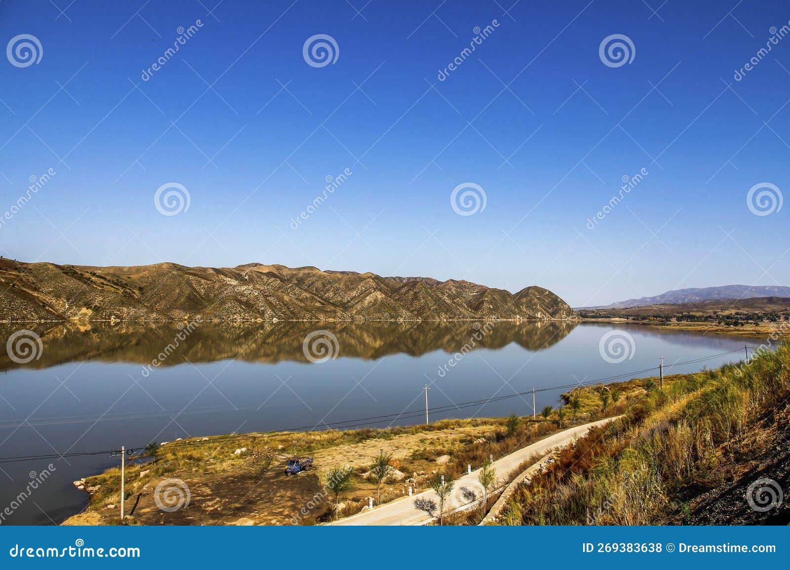 The Calm Blue Lake Reflects the Blue Sky and Mountains Stock Photo ...