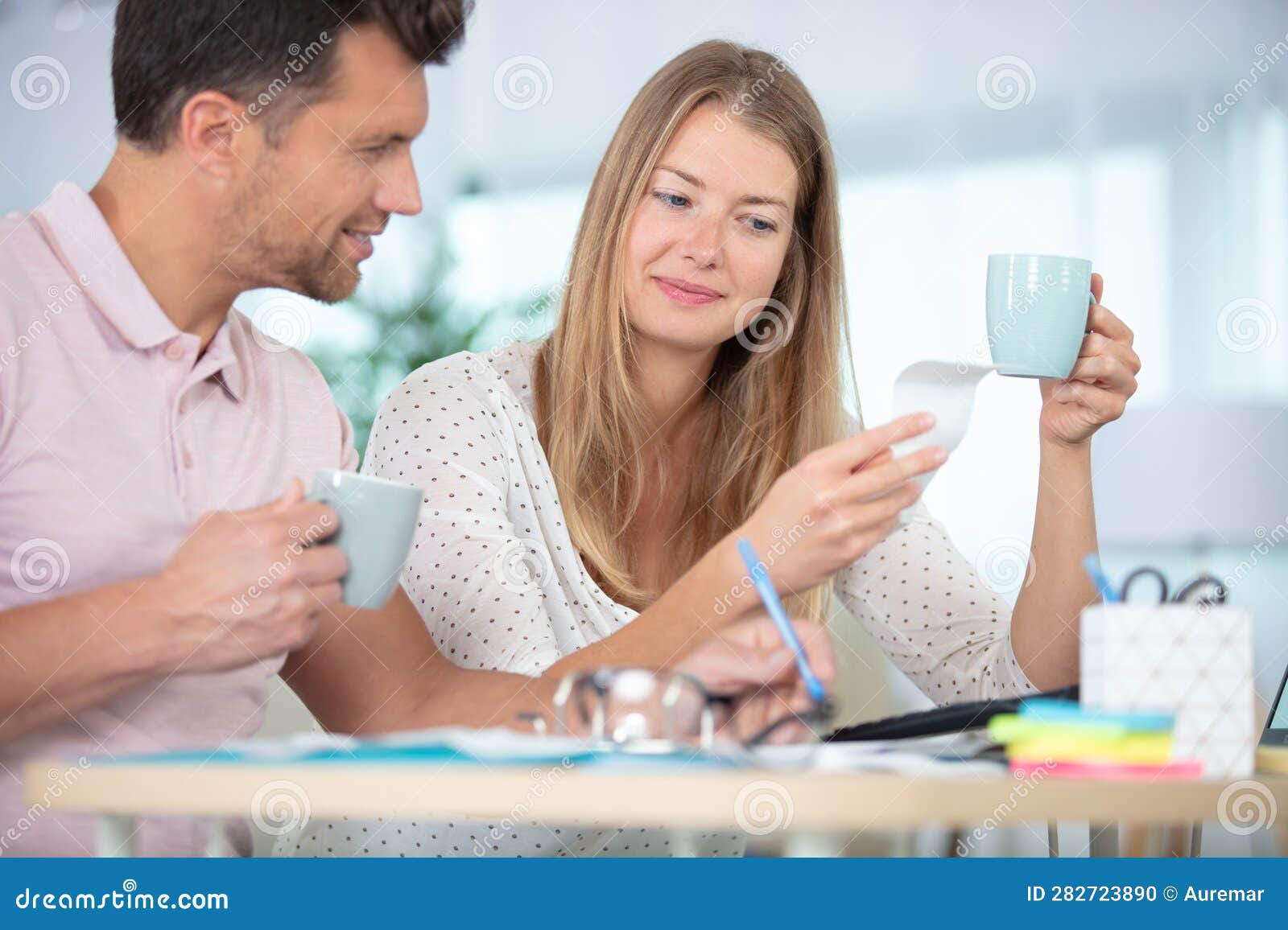 Calm Couple Looking at Paperwork while Having Coffee Stock Photo ...