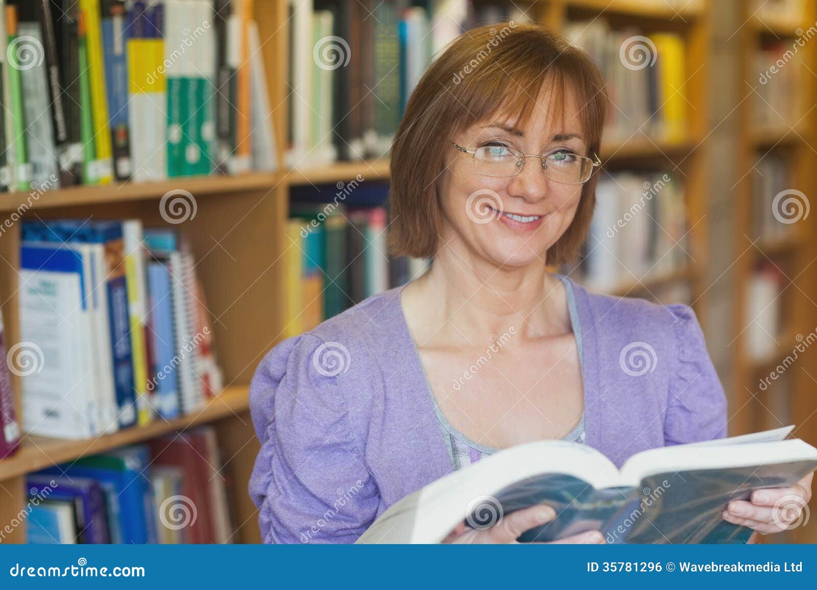 Calm Female Librarian Posing Holding an Opened Book Stock Photo - Image ...