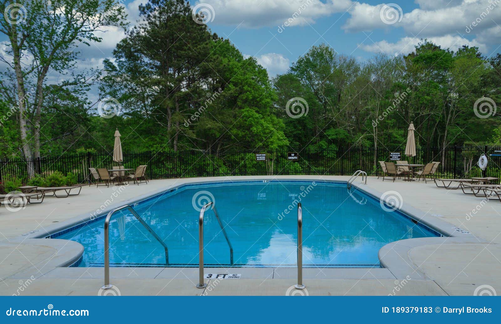 Calm Neighborhood Pool stock image. Image of lounges - 189379183