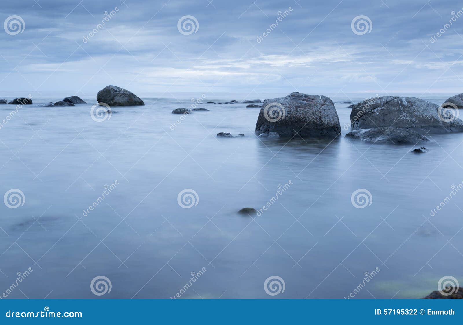 Calm Ocean with Rocks stock photo. Image of grass, clouds - 57195322