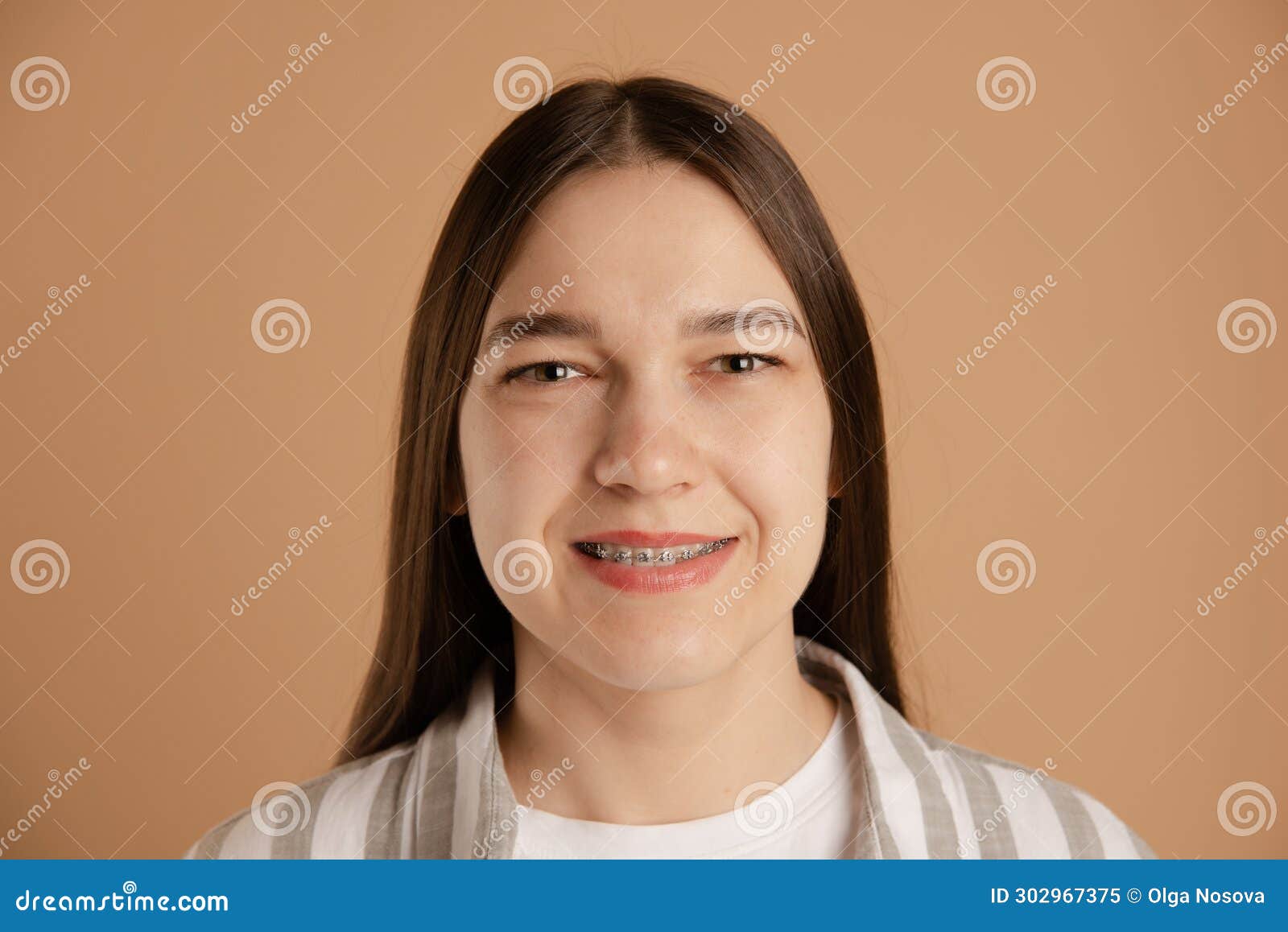Calm Smiling Girl with Braces Look at Camera on Studio Beige Background ...