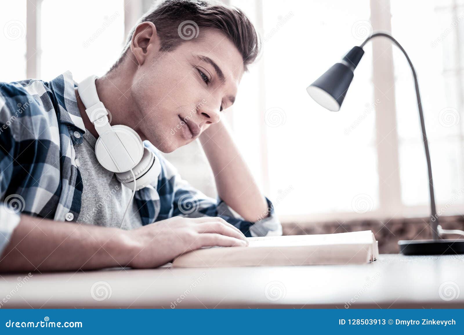 Calm Student Thoughtfully Sitting Alone and Reading the Book Stock ...