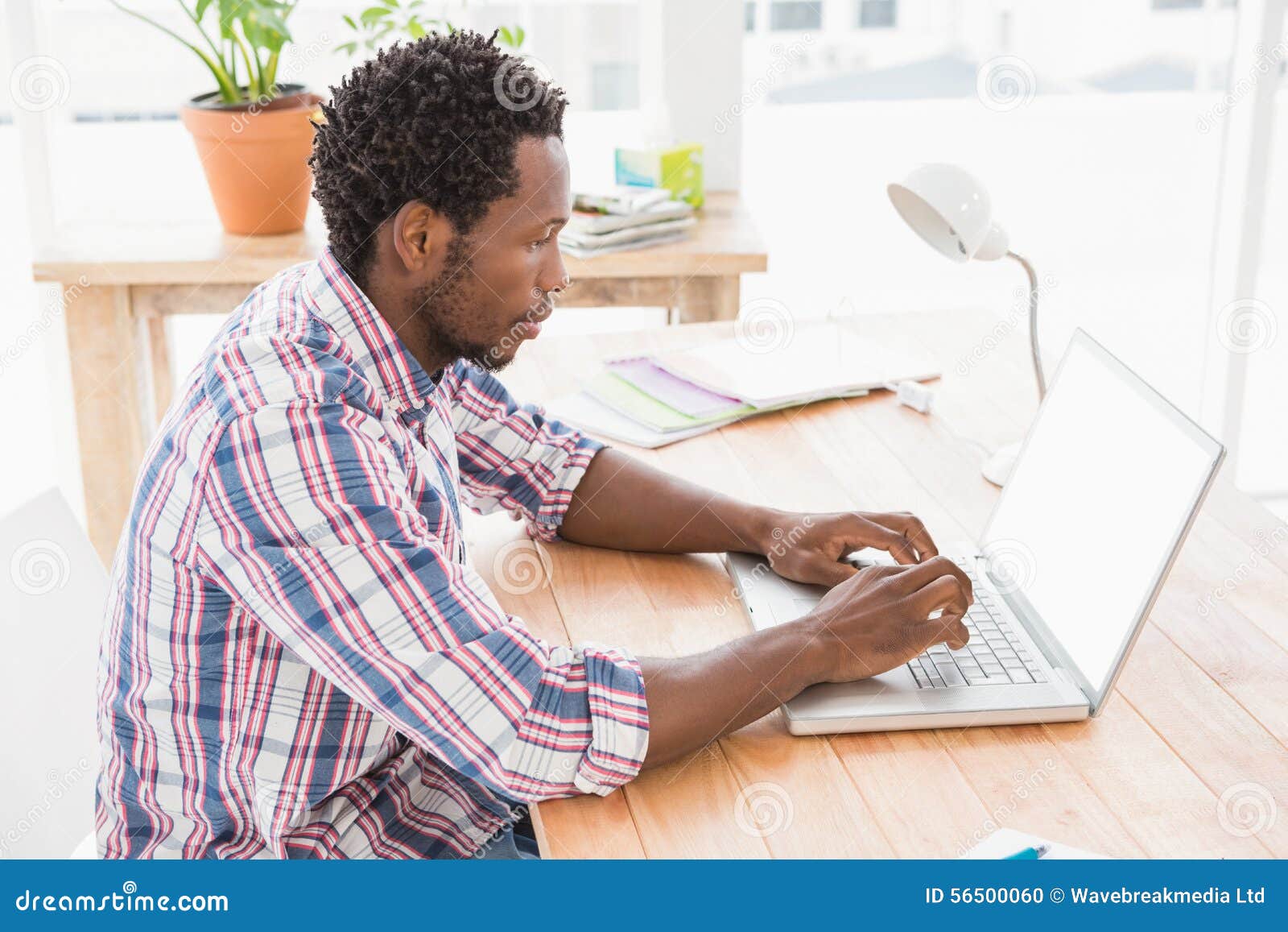 Calm Young Man Sitting in Front of a Laptop Stock Photo - Image of ...