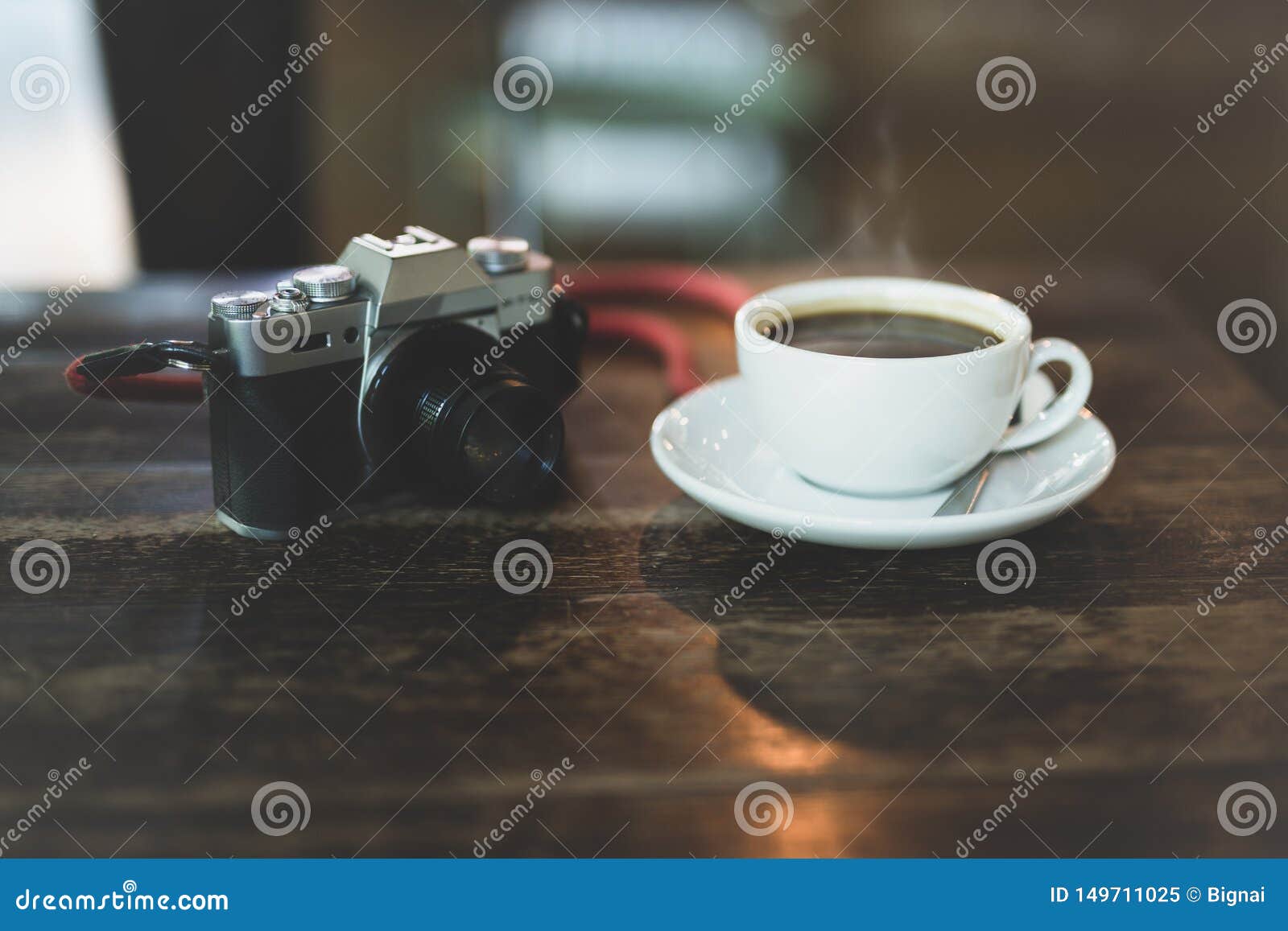 Camera and Coffee Cup on Wooden Table in the Morning. Stock Image ...