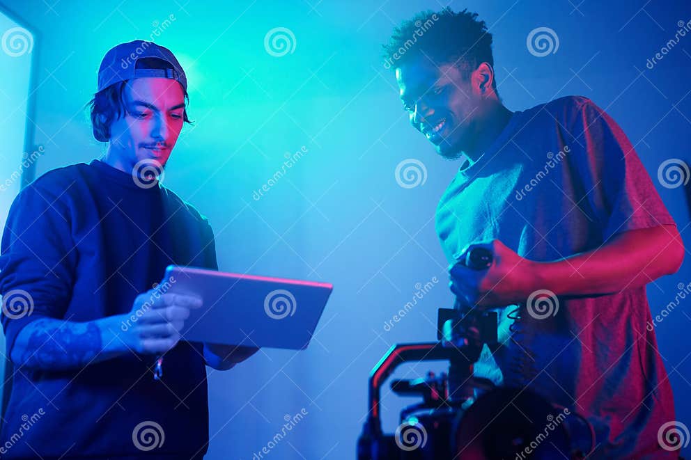 Camera Crew Using Tablet Pc during Shooting Stock Image - Image of ...