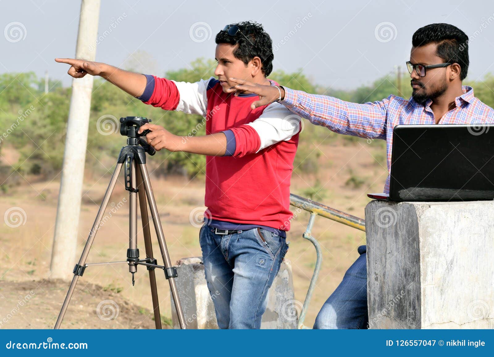 Camera Man Filming. Shot Angle and Second One is Working on Laptop ...