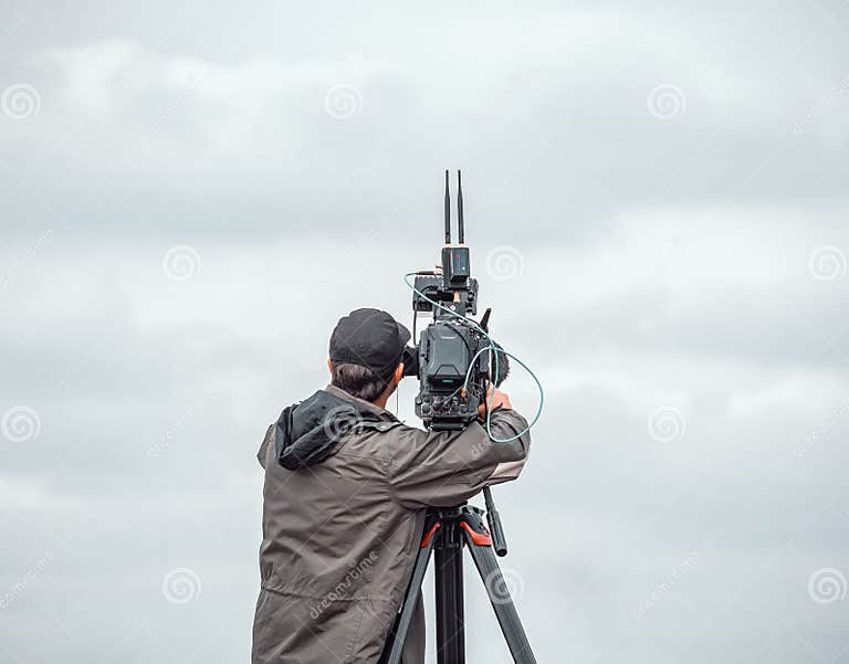 Camera Operator Filming an Event in Bucharest, Romania, Using a Modern ...