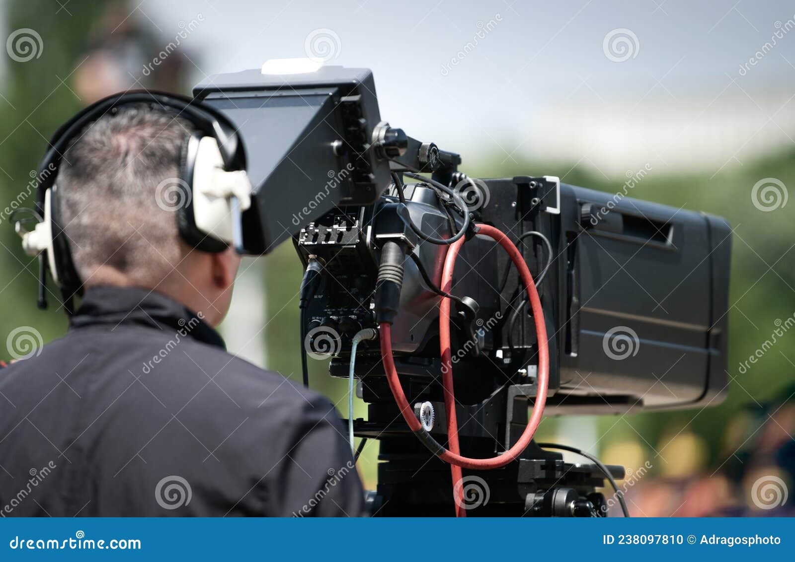Camera Operator Working with a Broadcasting Television Camera Stock ...