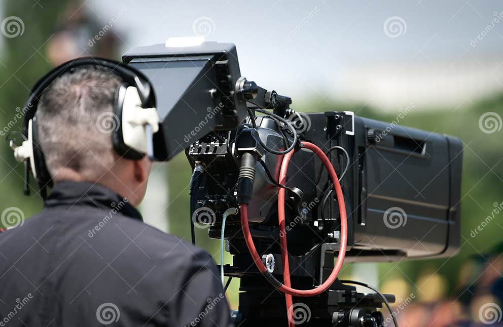 Camera Operator Working with a Broadcasting Television Camera Stock ...