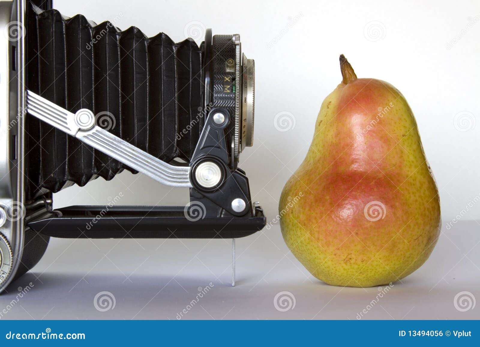 Camera and pear. stock photo. Image of fruit, still, life - 13494056