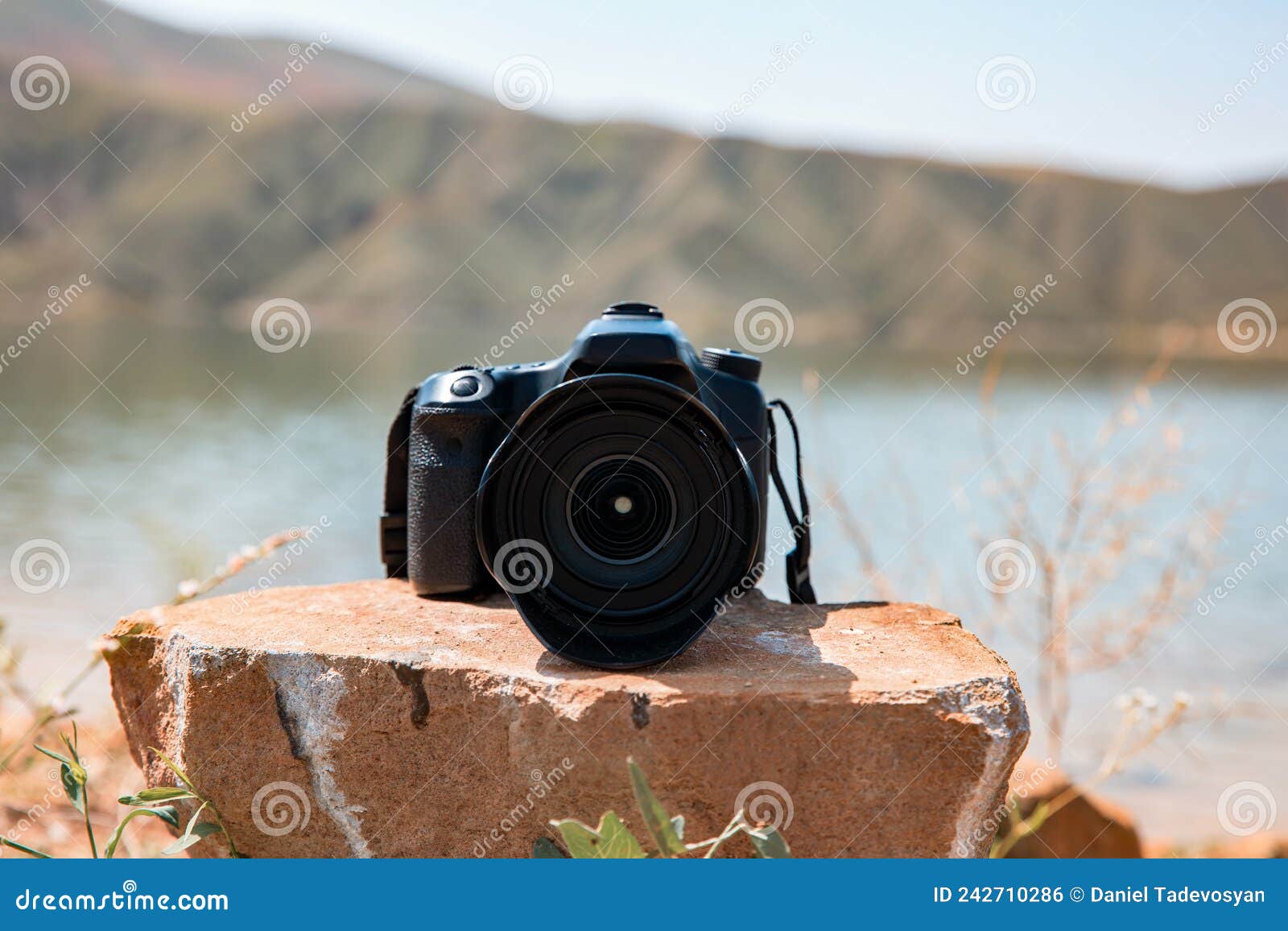 Camera on Stone on the Lake Background Stock Photo - Image of camera ...