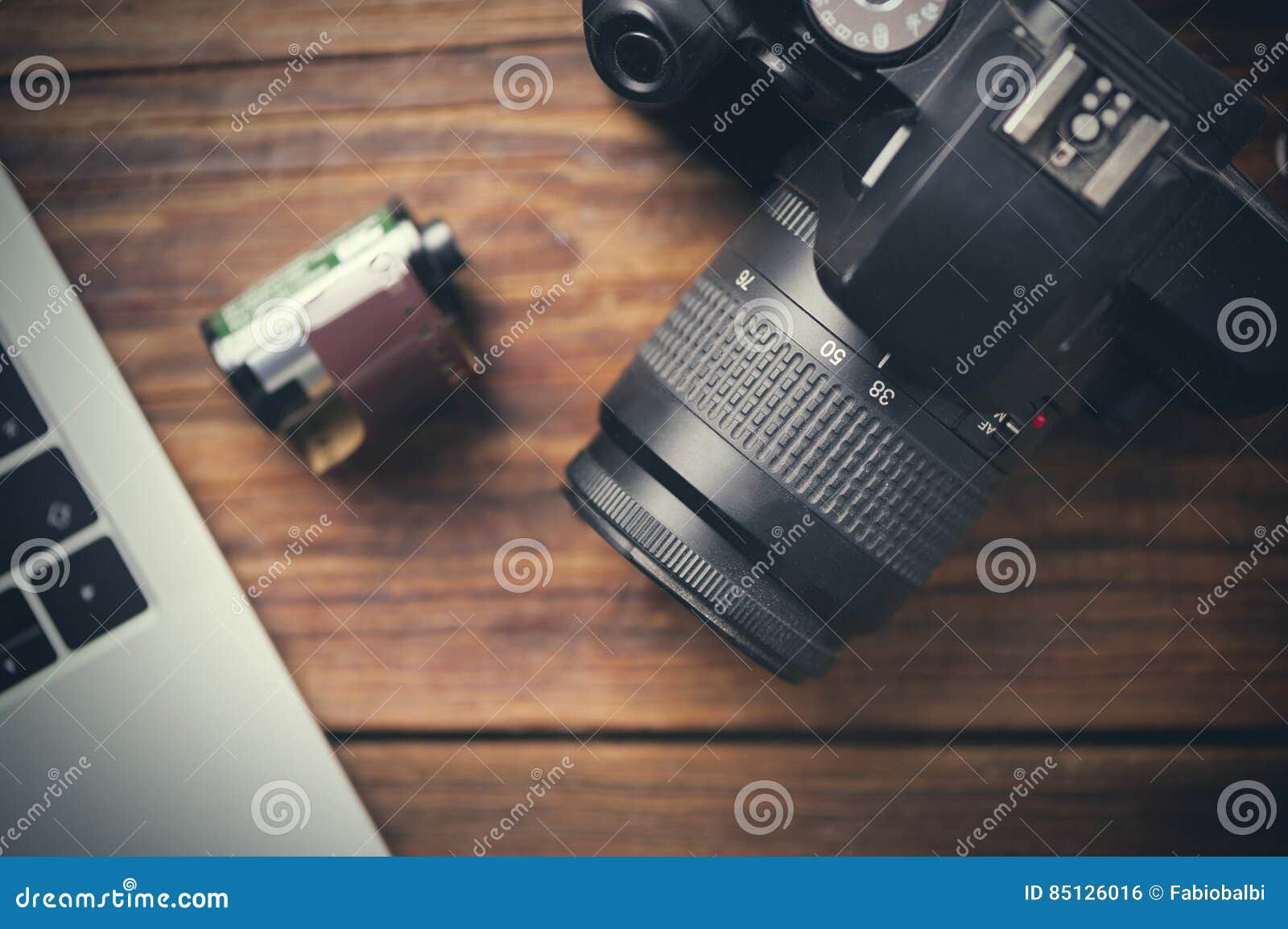 Camera on Wooden Table with Computer and Roll Stock Photo - Image of ...
