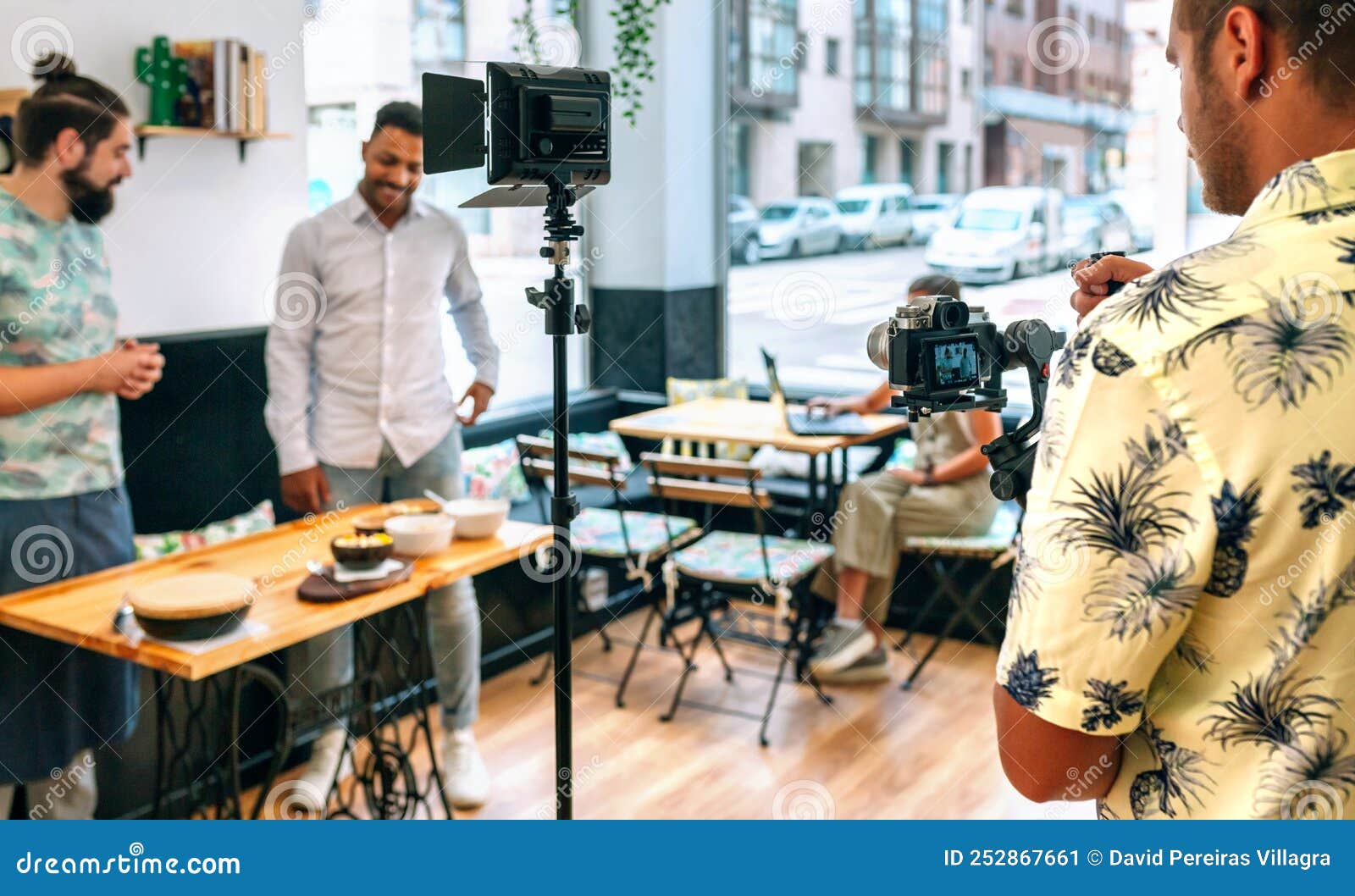 Cameraman Recording a Cooking Tutorial that is Broadcast Live Stock ...