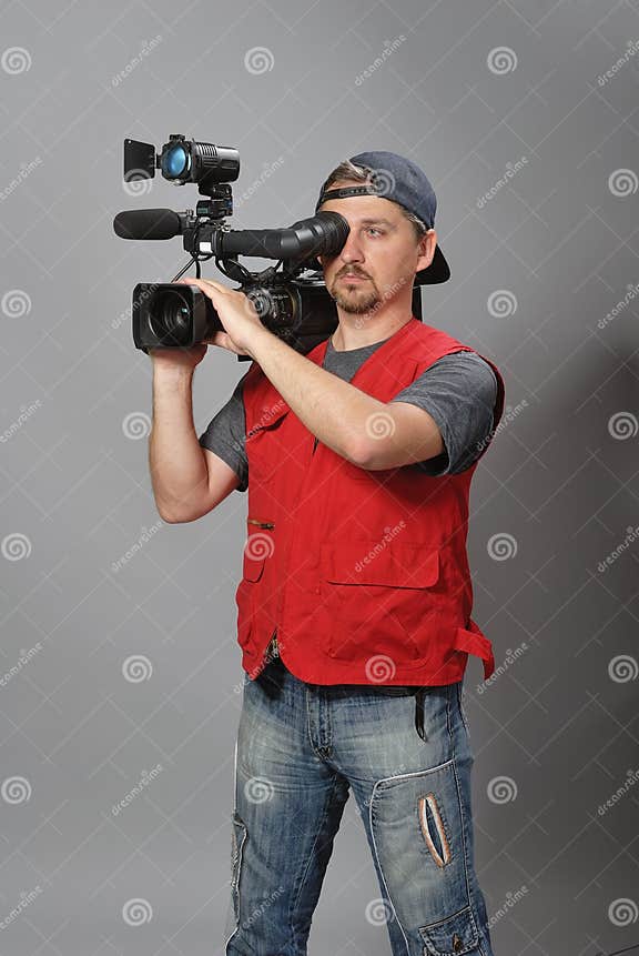 Cameraman in red vest stock photo. Image of microphone - 14689552
