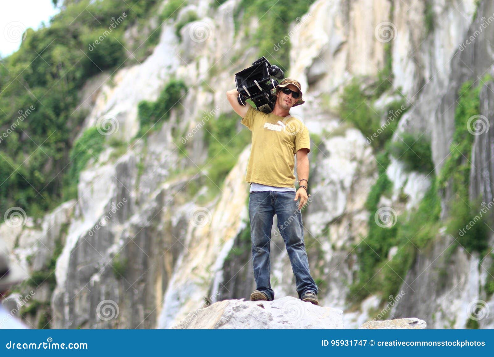 Cameraman Standing On Rocky Ledge Picture. Image: 95931747