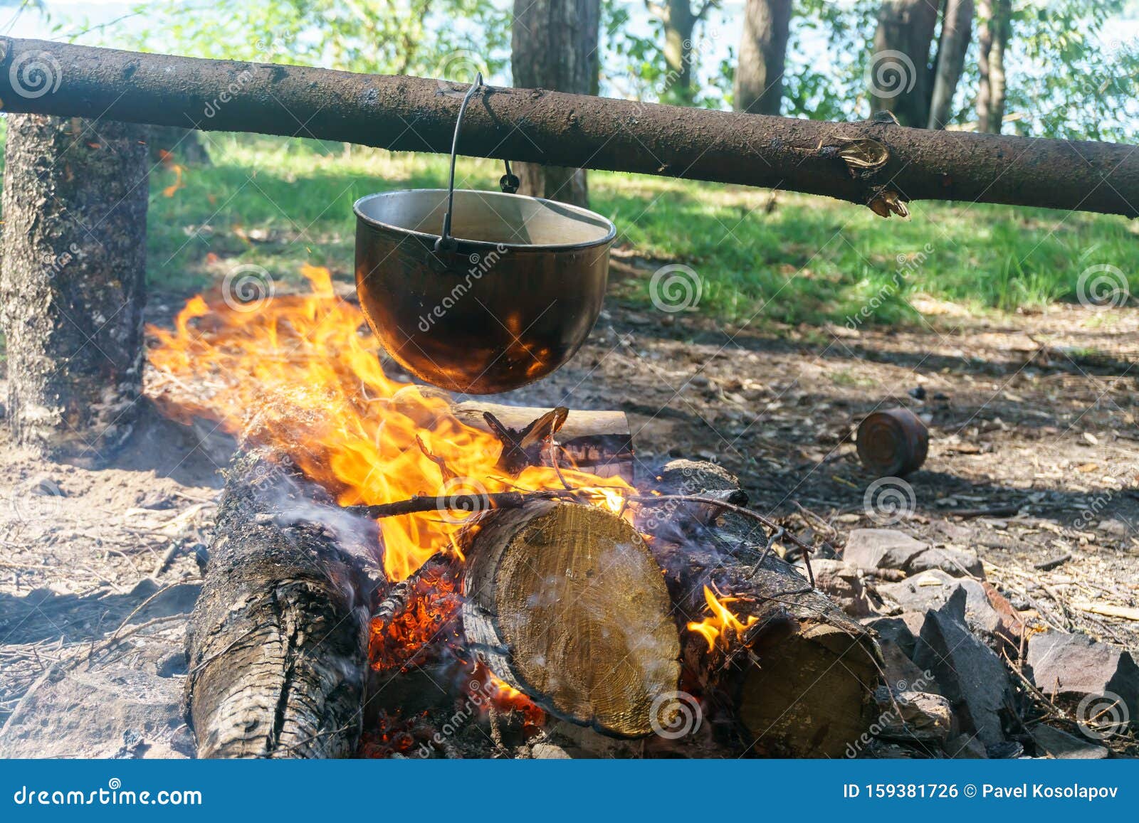 Camp pot on the fire stock photo. Image of background - 159381726