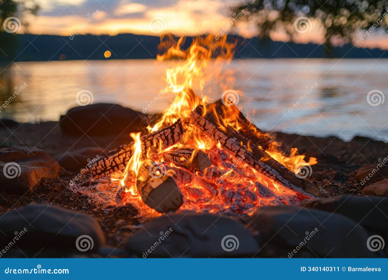 Campfire Burning by a Lakeside with Mountains in Background Stock Image ...
