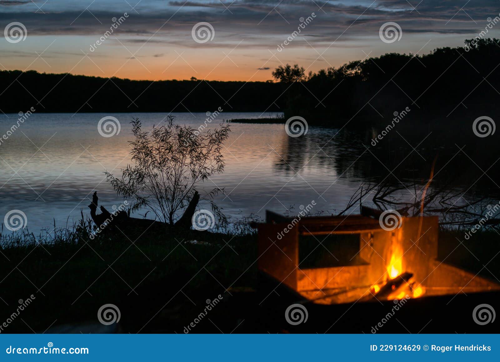 Campfire by the lake stock image. Image of evening, reflection - 229124629