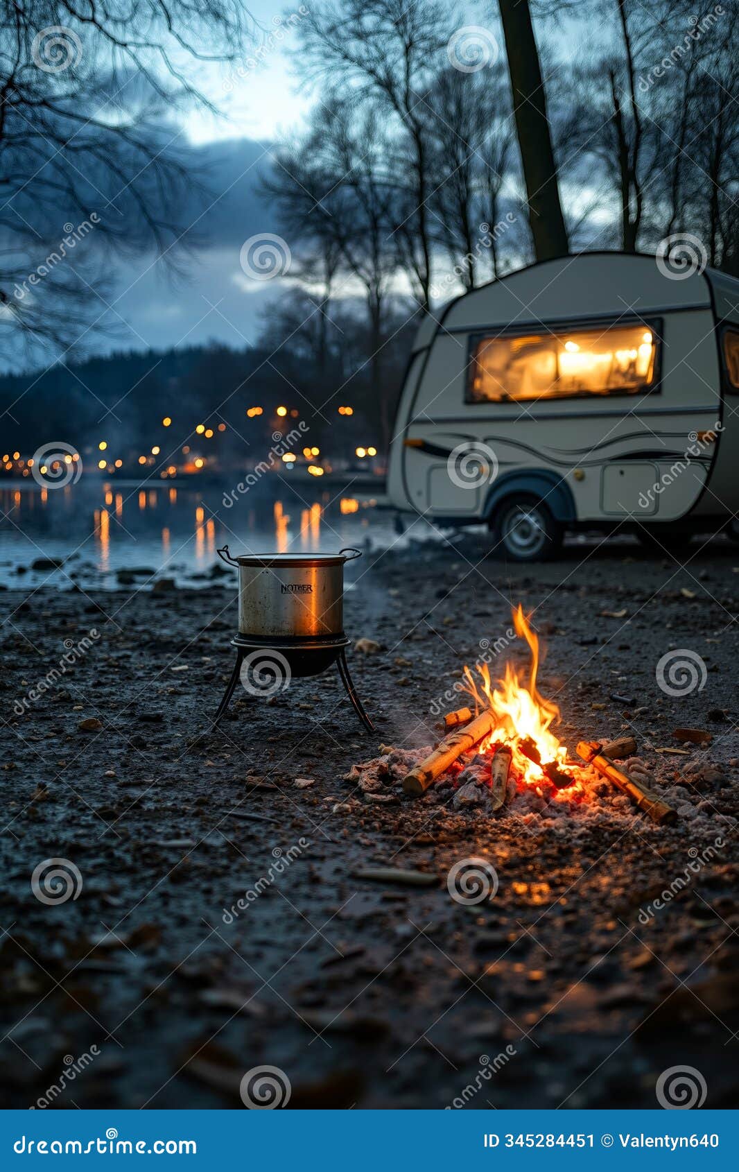 A Campfire with a Pot on Top of it Next To a Camper Trailer Stock Image ...