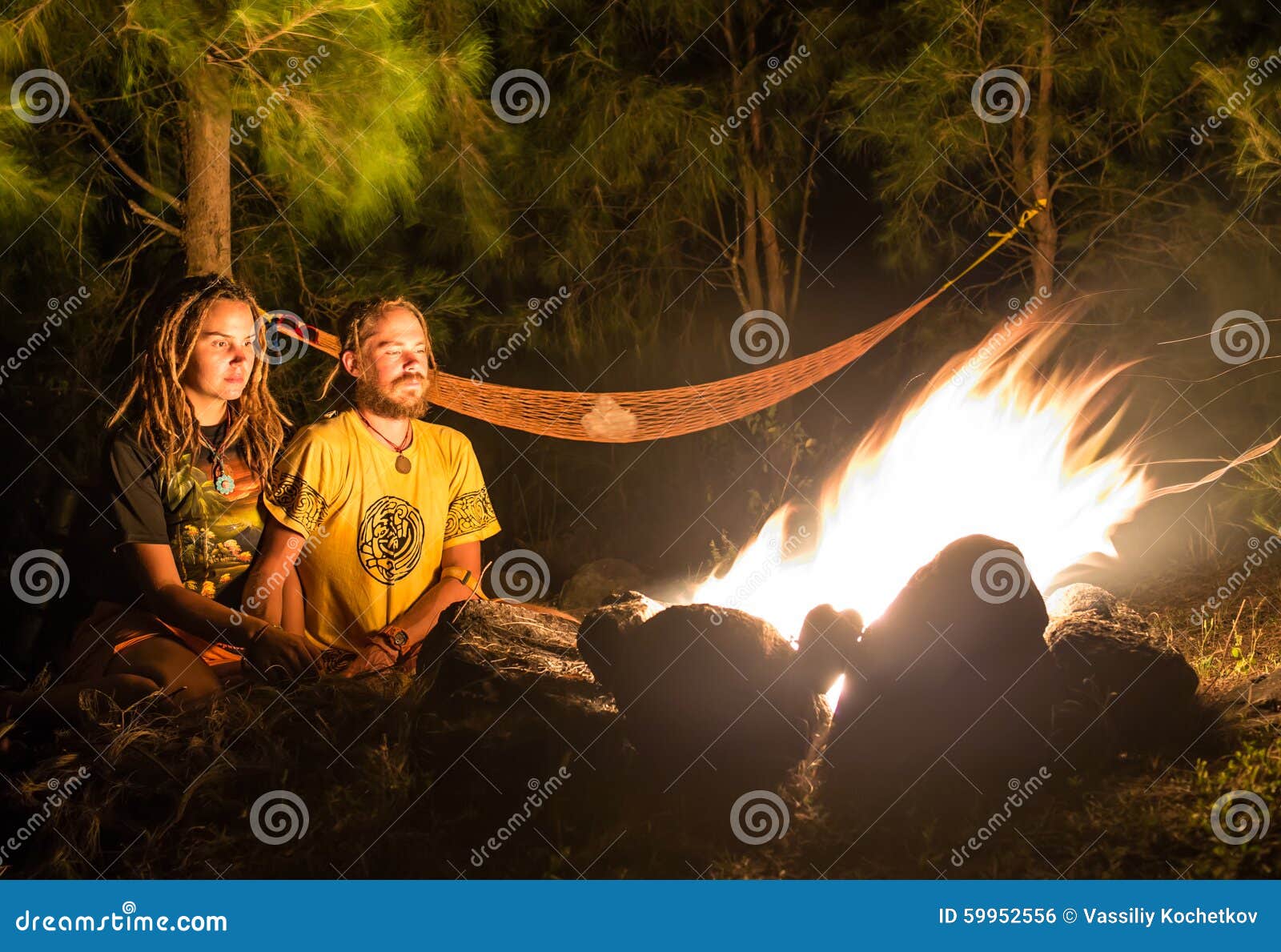 Campfire on a Rocky Beach with Couple Sitting Stock Photo - Image of ...