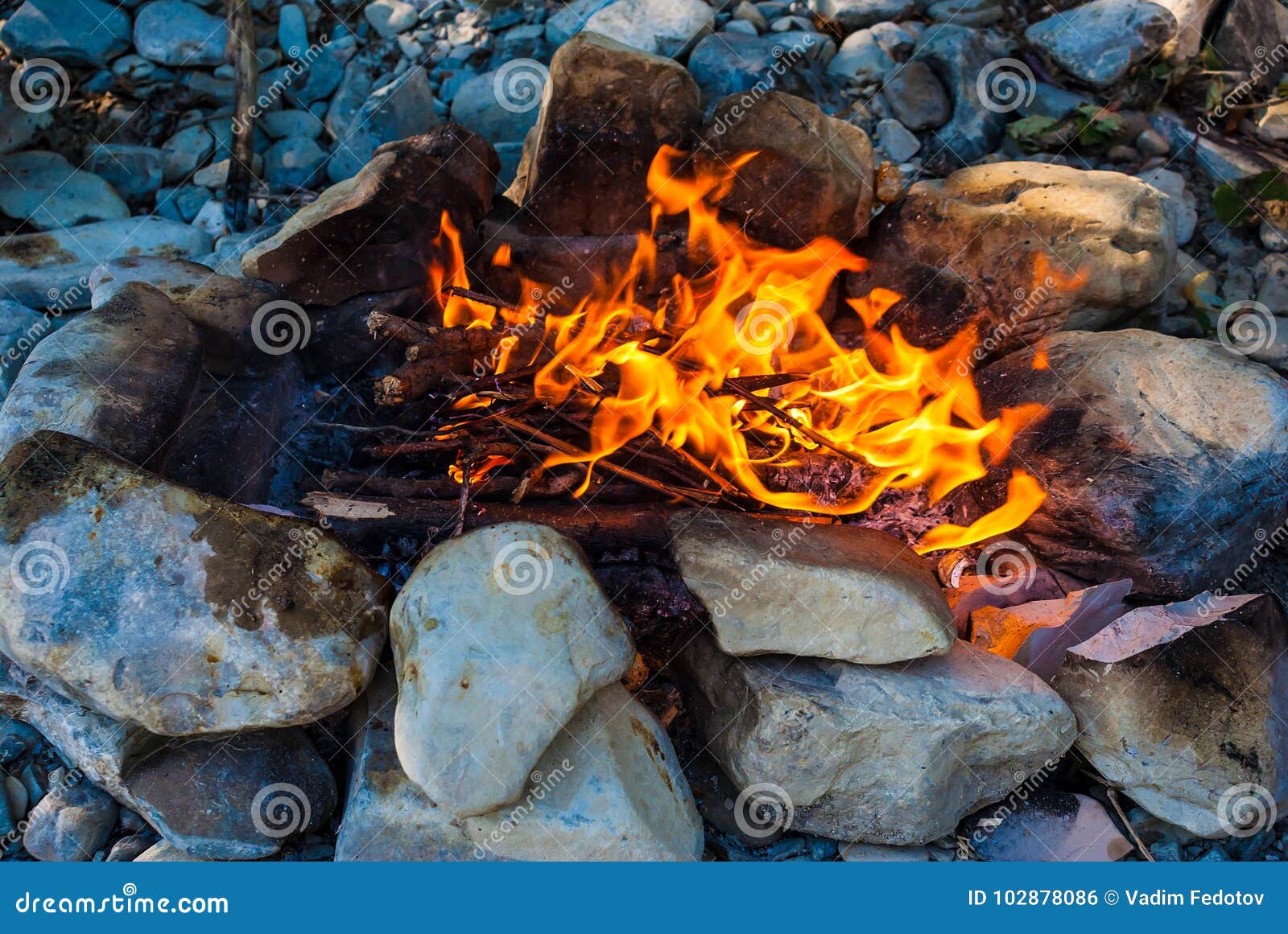 Campfire Surrounded by Rocks Stock Photo - Image of blaze, flame: 102878086