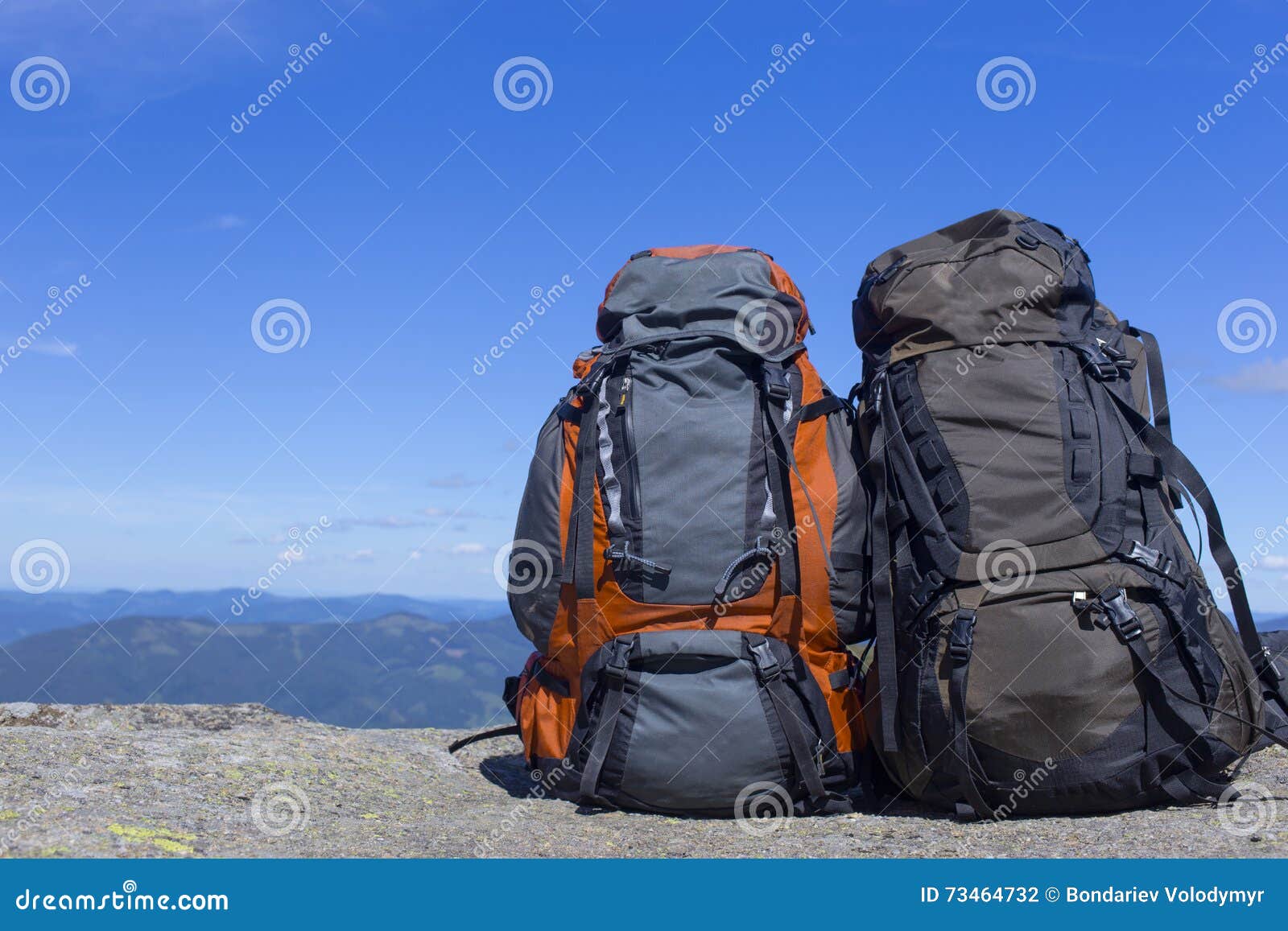 Camping with Backpacks in the Mountains Against the Blue Sky. Stock ...