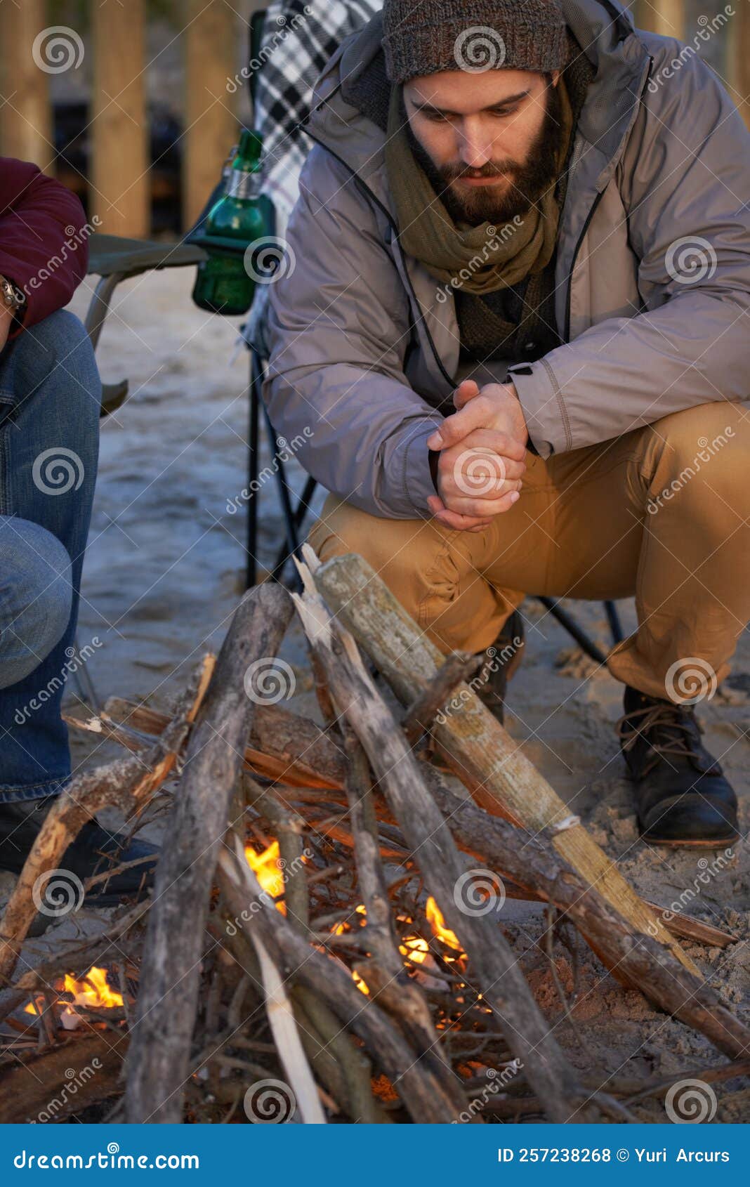 Camping Out on the Beach. a Young Man Making a Fire on the Beach. Stock ...