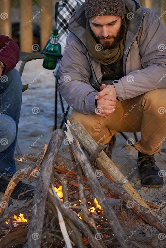 Camping Out on the Beach. a Young Man Making a Fire on the Beach. Stock ...