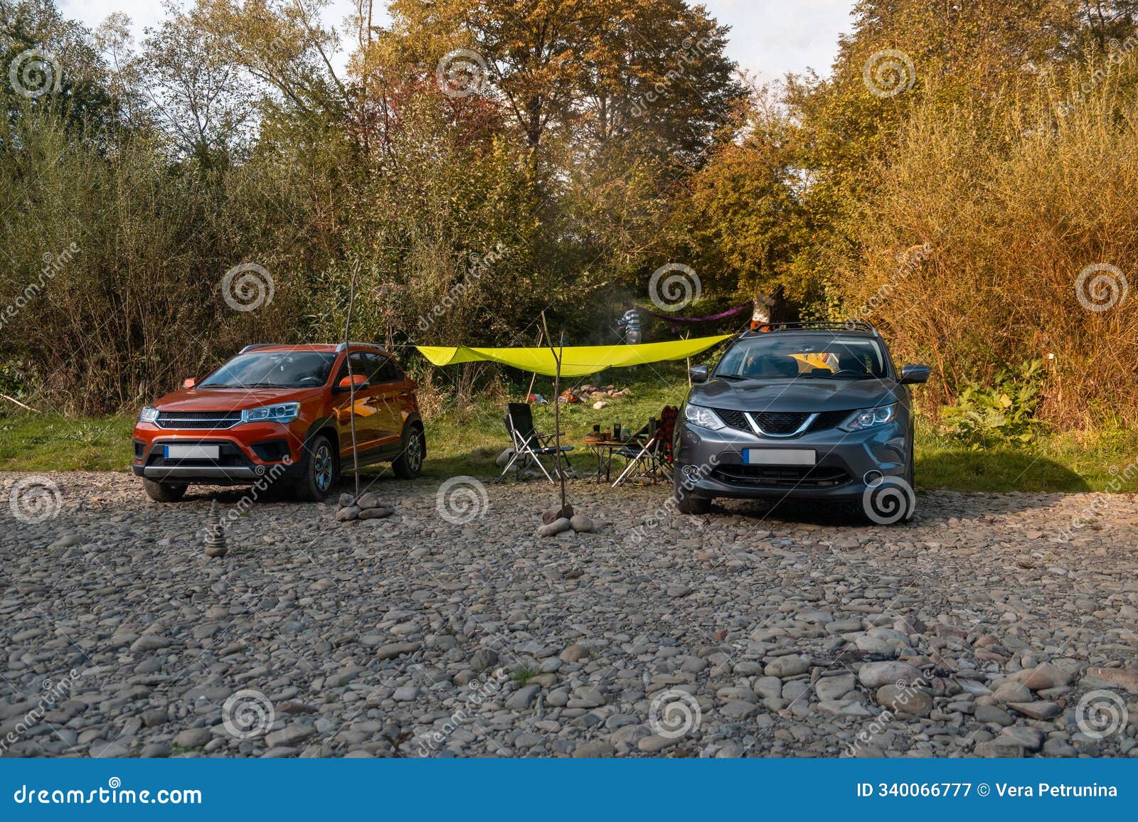 Camping Setup by the Riverbank with Cars Stock Image - Image of tarp ...