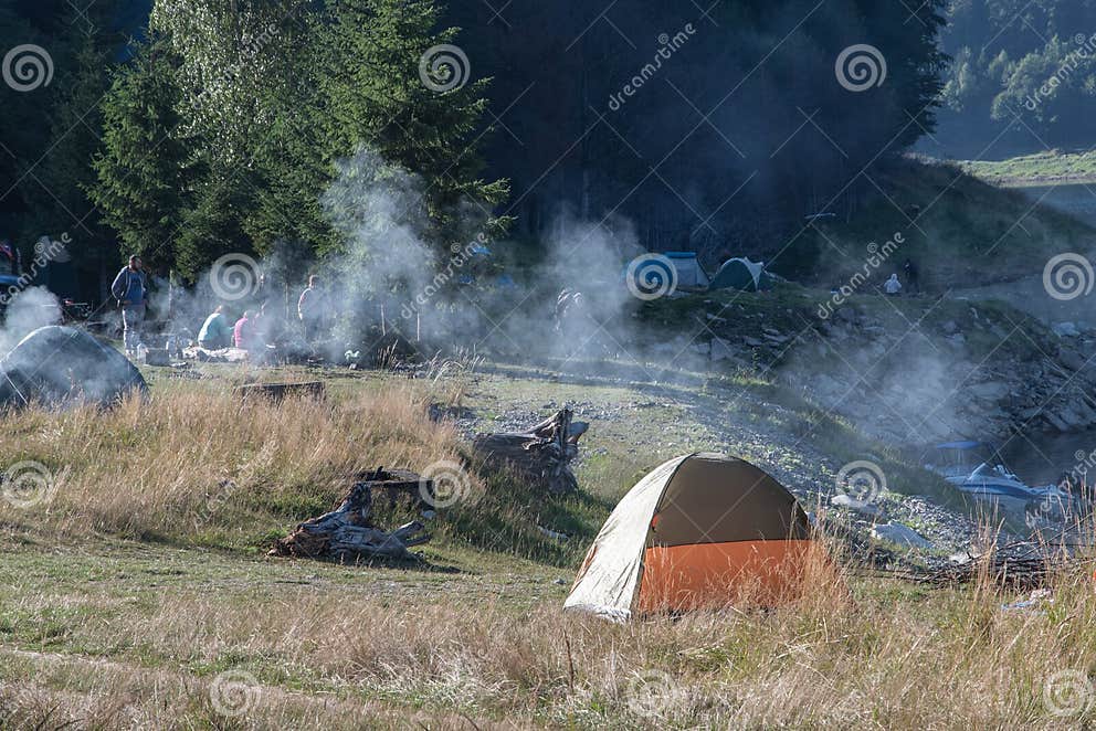 Camping with Tent and Smoke Stock Photo - Image of people, mountain ...
