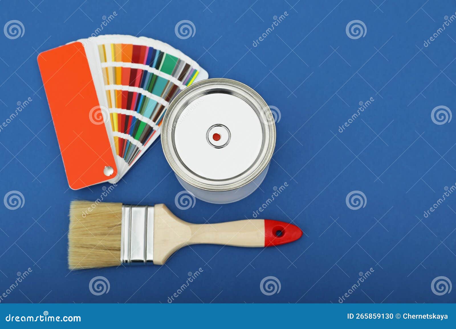 Can of Orange Paint, Color Palette Samples and Brushes on Blue ...
