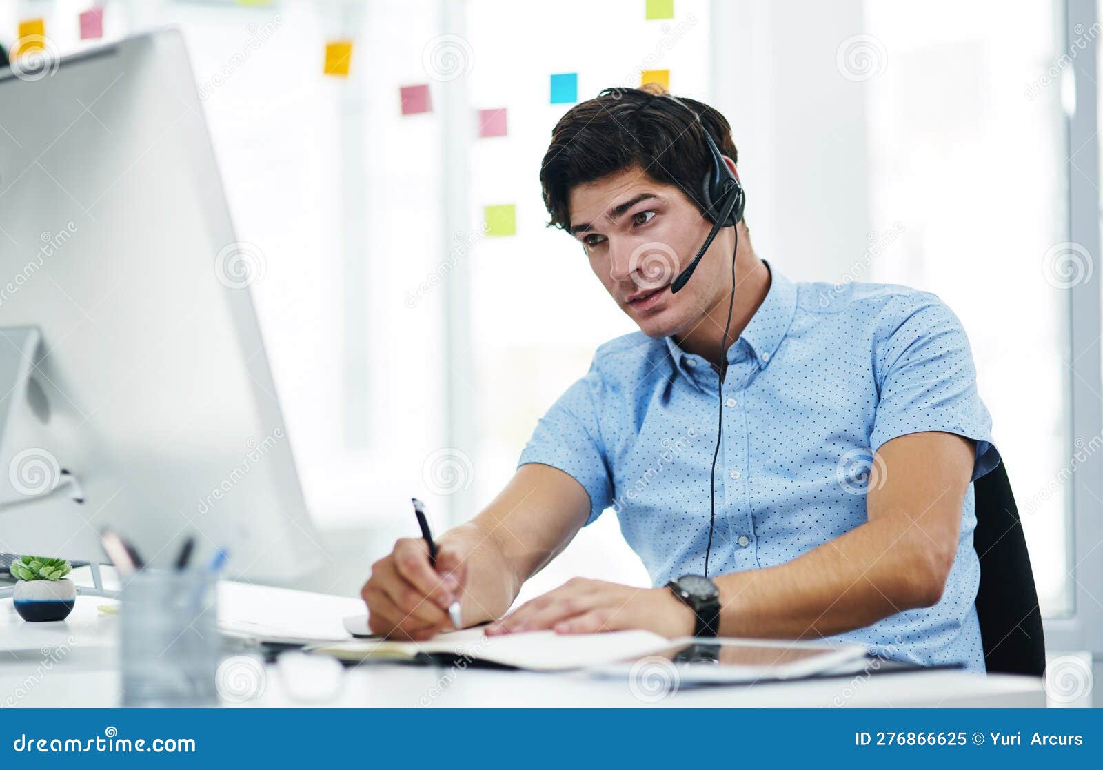 Can You Repeat that for Me Please. a Young Businessman Using a Headset ...